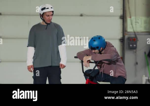 Slowmo portrait of two young Caucasian male BMX riders in protective ...