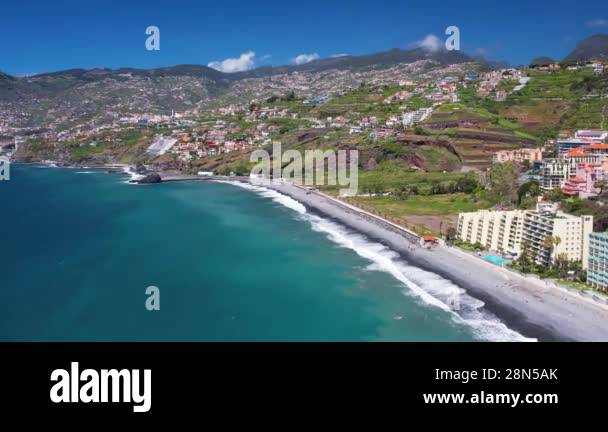 Aerial view of turquoise waters of Praia Formosa beach and colorful ...