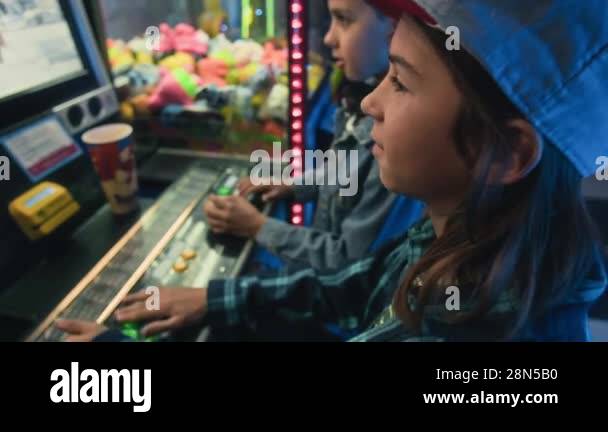 Medium side shot of two young teenage boys competing against each other while playing video game ...