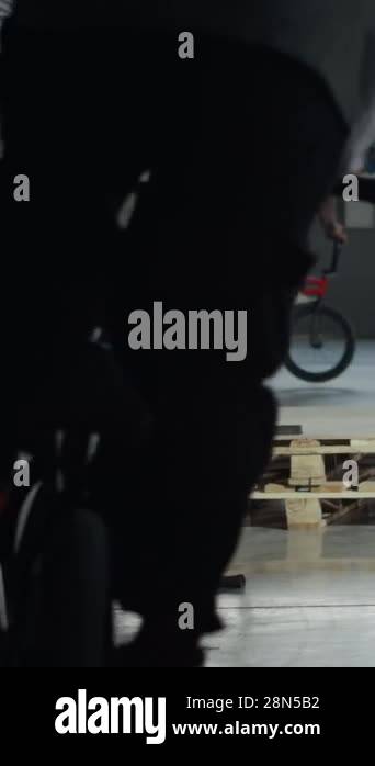 Vertical full back shot of young experienced guy riding BMX bike and ...