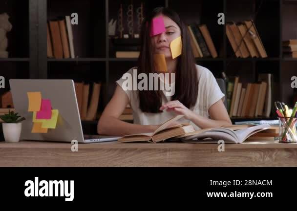 Angry, sad and tired brunette student with many colorful stickers on ...