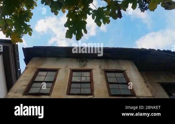 Historical architecture with rustic facade captured under moving sky ...