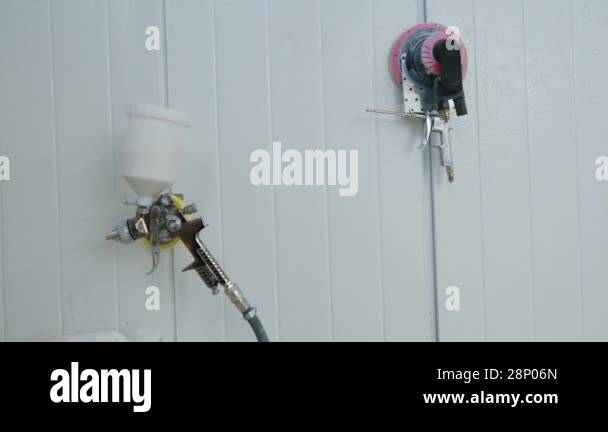 closeup shot of a spray gun hanging on wall, carpenter service. High ...