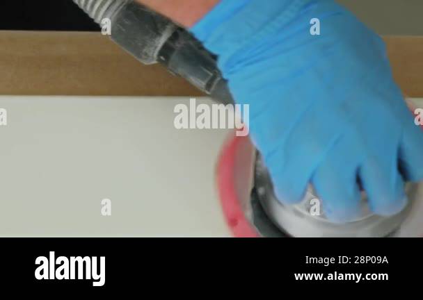 carpenter working in his workshop.he finishing wooden plank with sand ...