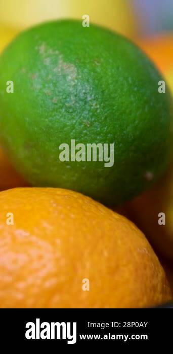Video shows a bright yellow lemon being cut with a sharp knife on a ...