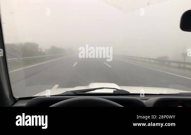 A video capturing the driver's perspective while navigating a foggy ...