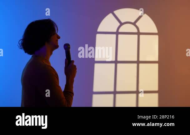 Person with mic on colorful studio background. Portrait of man ...