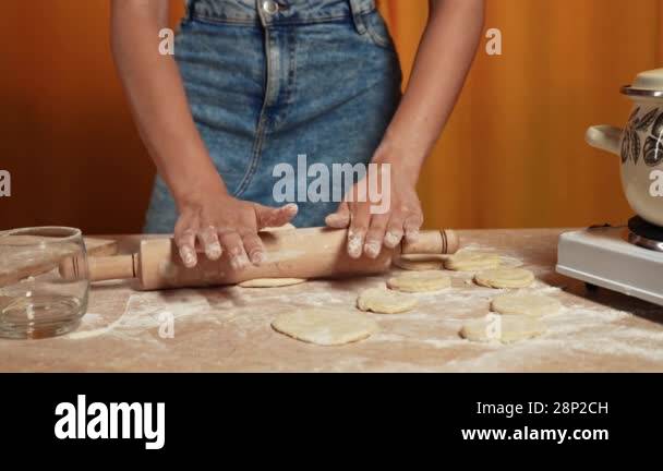 Home cooking daily routine. Woman stands at the table at home in the ...