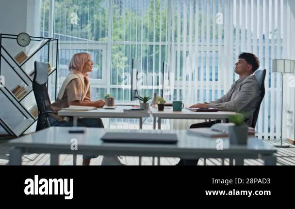 Relaxed colleagues having break talking at agency. Resting man ...