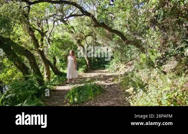 Relaxed woman strolling sunlight jungles. Smiling gentle lady enjoying ...