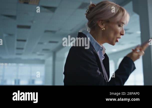 Portrait angry ceo shouting cellphone at office hall. Nervous ...