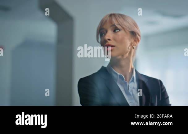 Elegant businesswoman standing modern office building with determined ...