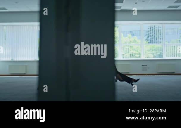 Happy young employee rides colleague on armchair in modern office hall ...