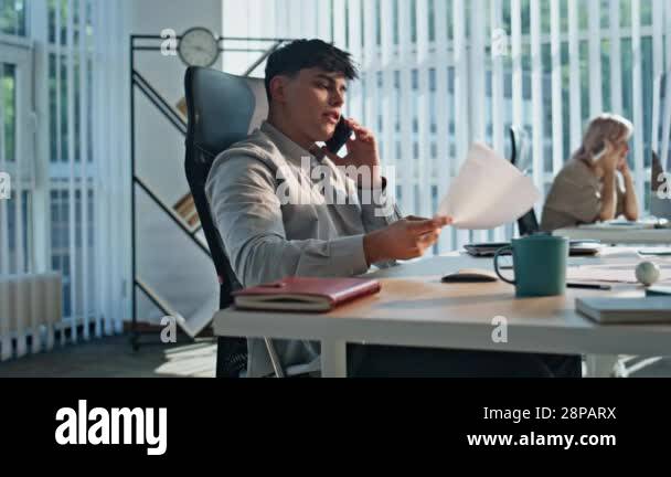 Upset sales manager calling cellphone at workplace closeup. Worried ...