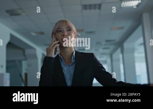 Closeup emotional businesswoman calling mobile phone stepping corporate ...