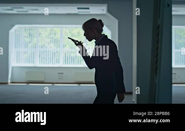 Annoyed stressed woman silhouette quarrelling using smartphone closeup ...