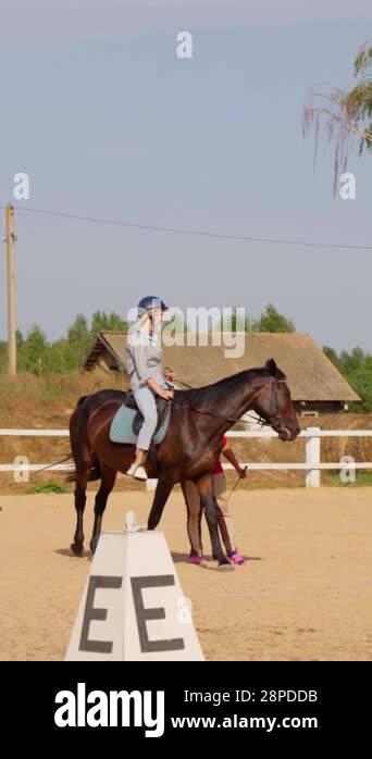 Horseback riding training session featuring young athlete trotting in ...