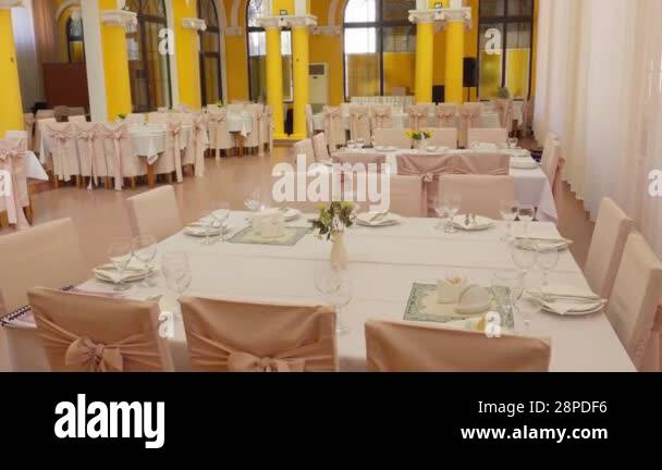 Large ballroom with round tables and beige chairs decorated with ...