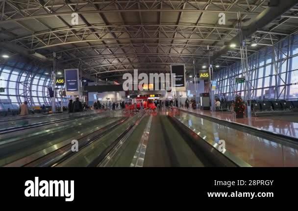 Spacious airport terminal with high ceilings, glass windows, gates A5 ...