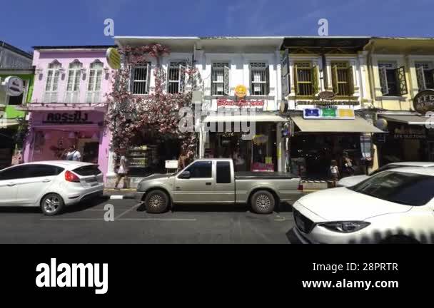 A vibrant street in Phuket Old Town, Thailand, with colorful shophouses ...