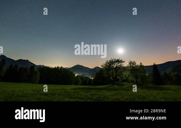 Star in Starry night sky with light of full moon moving over ...