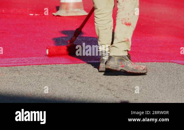 Process of painting for speed restricting road surface marking with red ...
