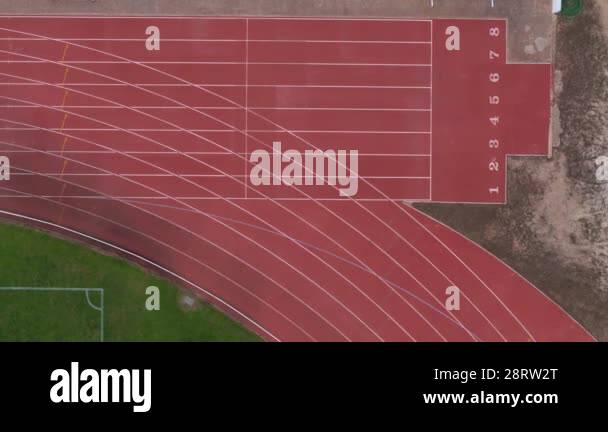 Aerial view of a local track field showcasing multiple running lanes ...