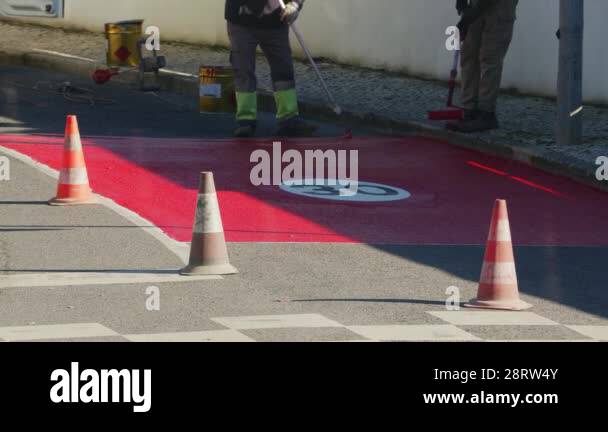 Process of painting for speed restricting road surface marking with red ...