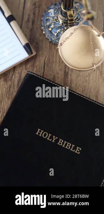 Holy bible book with antique balance scale and notebook on wooden ...