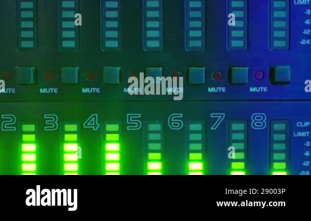 A captivating closeup shows an audio mixer display with vibrant green ...
