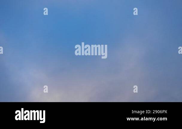 Observe dynamic flow of clouds against a vibrant blue sky, real time ...