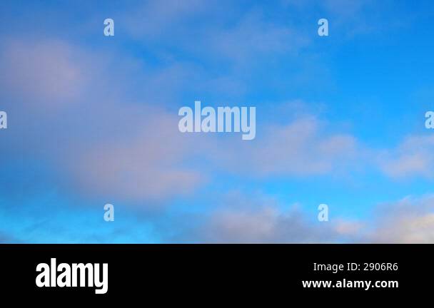 Observe dynamic flow of clouds against a vibrant blue sky, real time ...