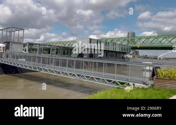 A video showing a modern riverside structure made of containers, a ...