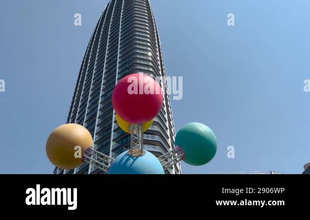 A modern cityscape featuring colorful spherical structures resembling a ...