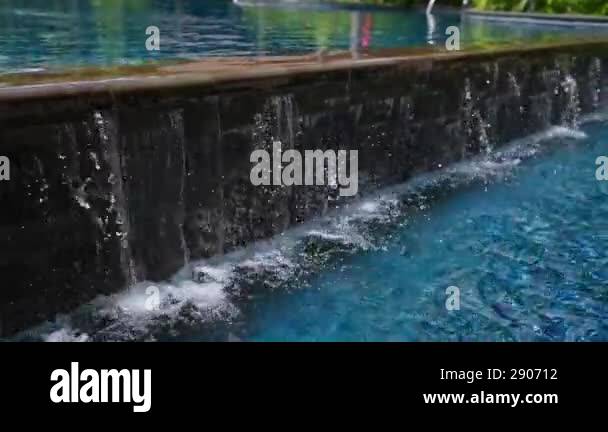 A tranquil poolside area surrounded by lush greenery, perfect for ...