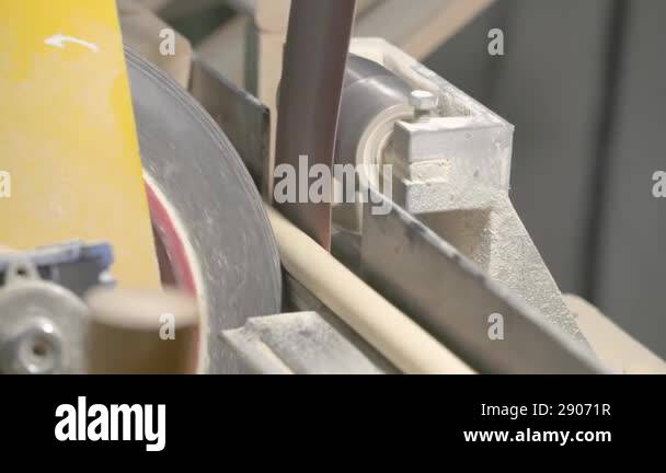 The video shows a woodworking process, where a spinning machine smooths ...
