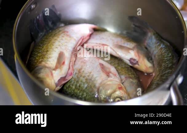 Frying fish in a frying pan. Tasty homemade roasted crucian carp Stock ...
