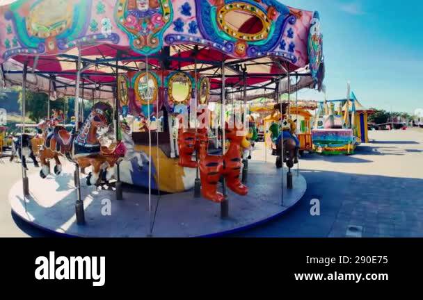 Colorful carousel spinning joyfully in a vibrant amusement park setting ...