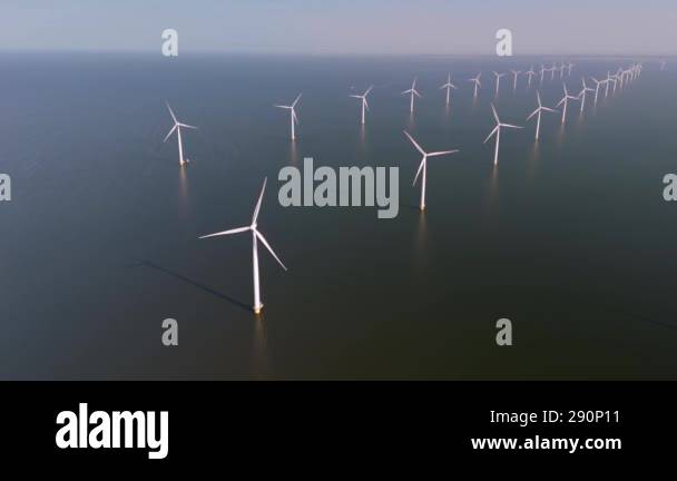 Windmill turbines stand majestically in the serene waters off the Dutch ...