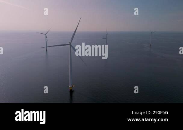 Majestic windmill turbines stand tall against the serene backdrop of ...