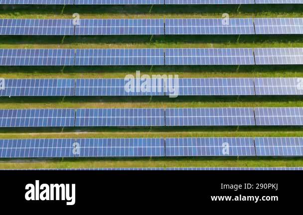 Large arrays of solar panels stretch across the lush fields of Thailand ...