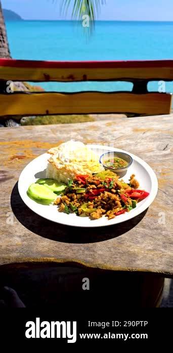 Tasting flavorful Thai dishes pad kaprow with vibrant colors against ...