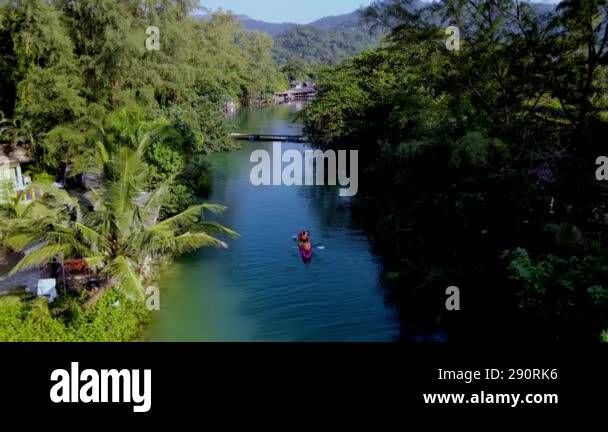 Explore the serene beauty of Koh Chang Thailand as a kayak glides ...