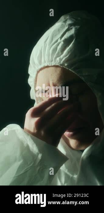 Vertical closeup lowkey portrait of devastated young Caucasian female ...