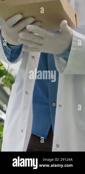 Vertical tilt up shot of young Caucasian male agricultural engineer ...