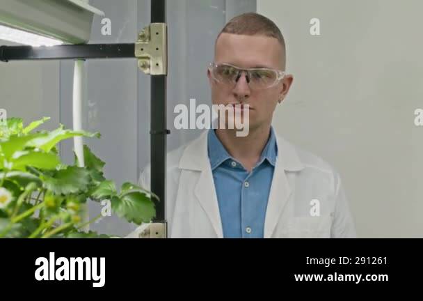Medium close up shot of young Caucasian male farmer in white uniform ...