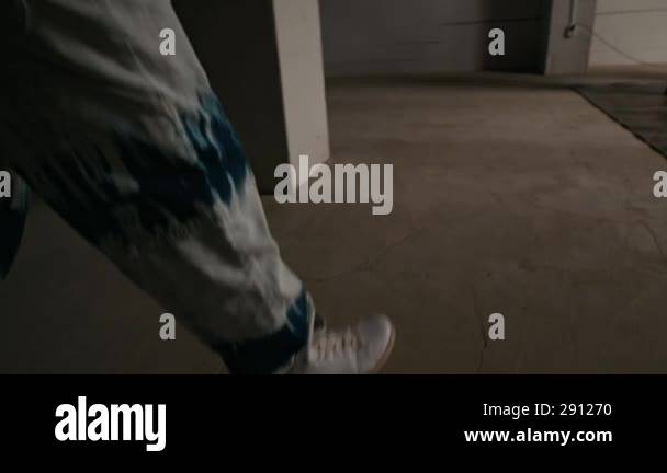 Slowmo tilt up shot of Caucasian male zoomer in oversized streetwear ...