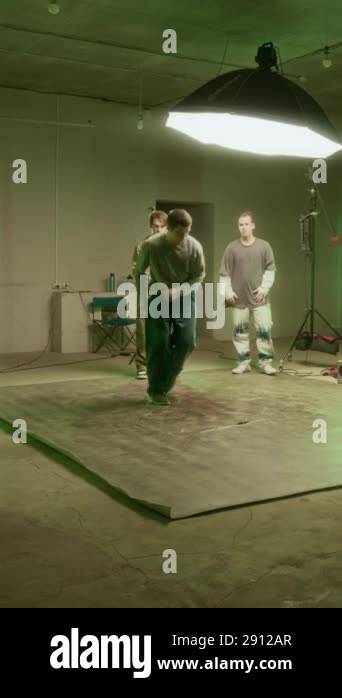 Vertical shot of Caucasian male zoomer in streetwear practicing ...