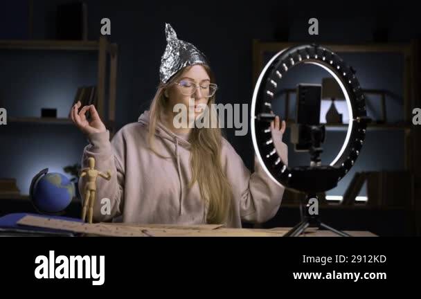 Strange crazy vlogger with cellphone, paranoid woman streaming at home ...