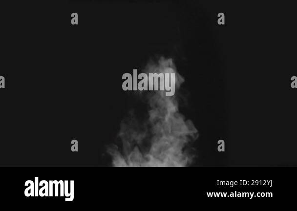 A stream of white steam, slowly swirling, moves upward against a black ...